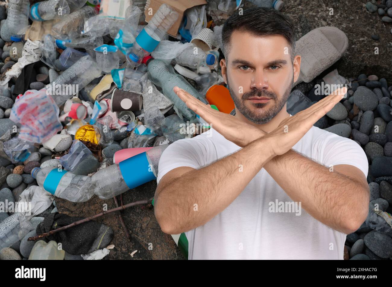 Environmental pollution. Man showing stop gesture. Garbage on ...