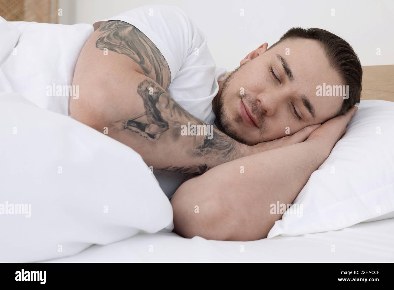 Bedtime. Handsome man sleeping in bed indoors Stock Photo - Alamy