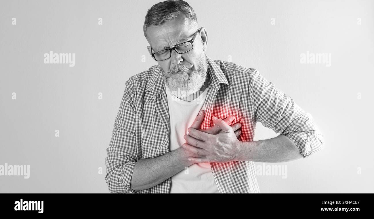 Heart attack. Senior man suffering from severe pain and pressing hands ...