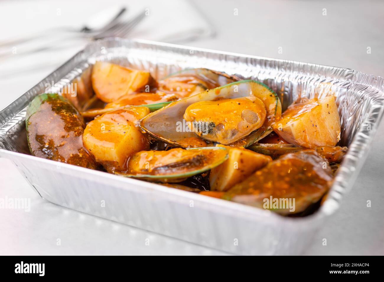 A view of a tin container of green mussels boil Stock Photo - Alamy