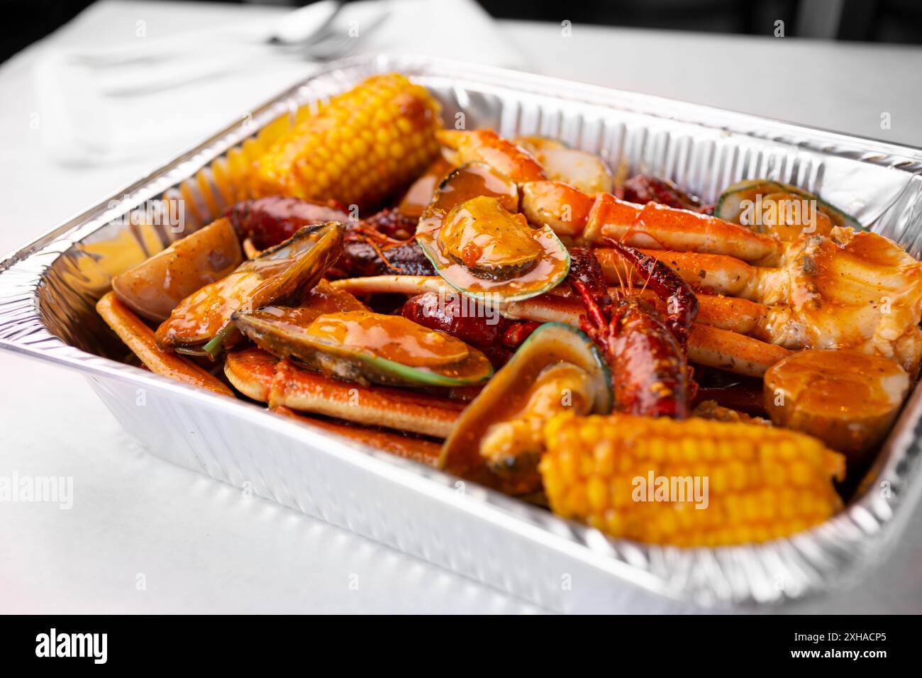 A view of a tin container of seafood boil Stock Photo - Alamy