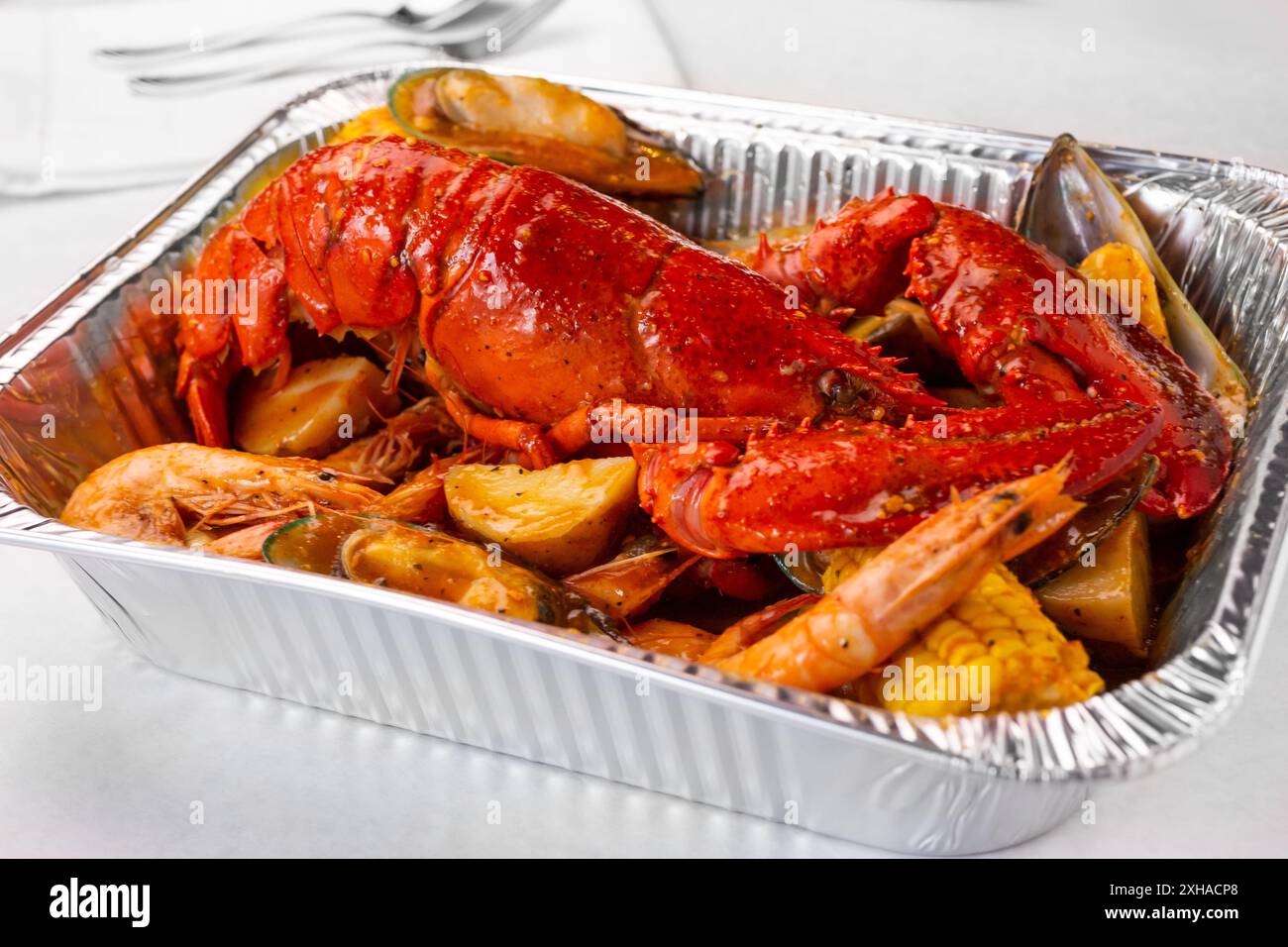 A view of a tin container of lobster boil Stock Photo - Alamy