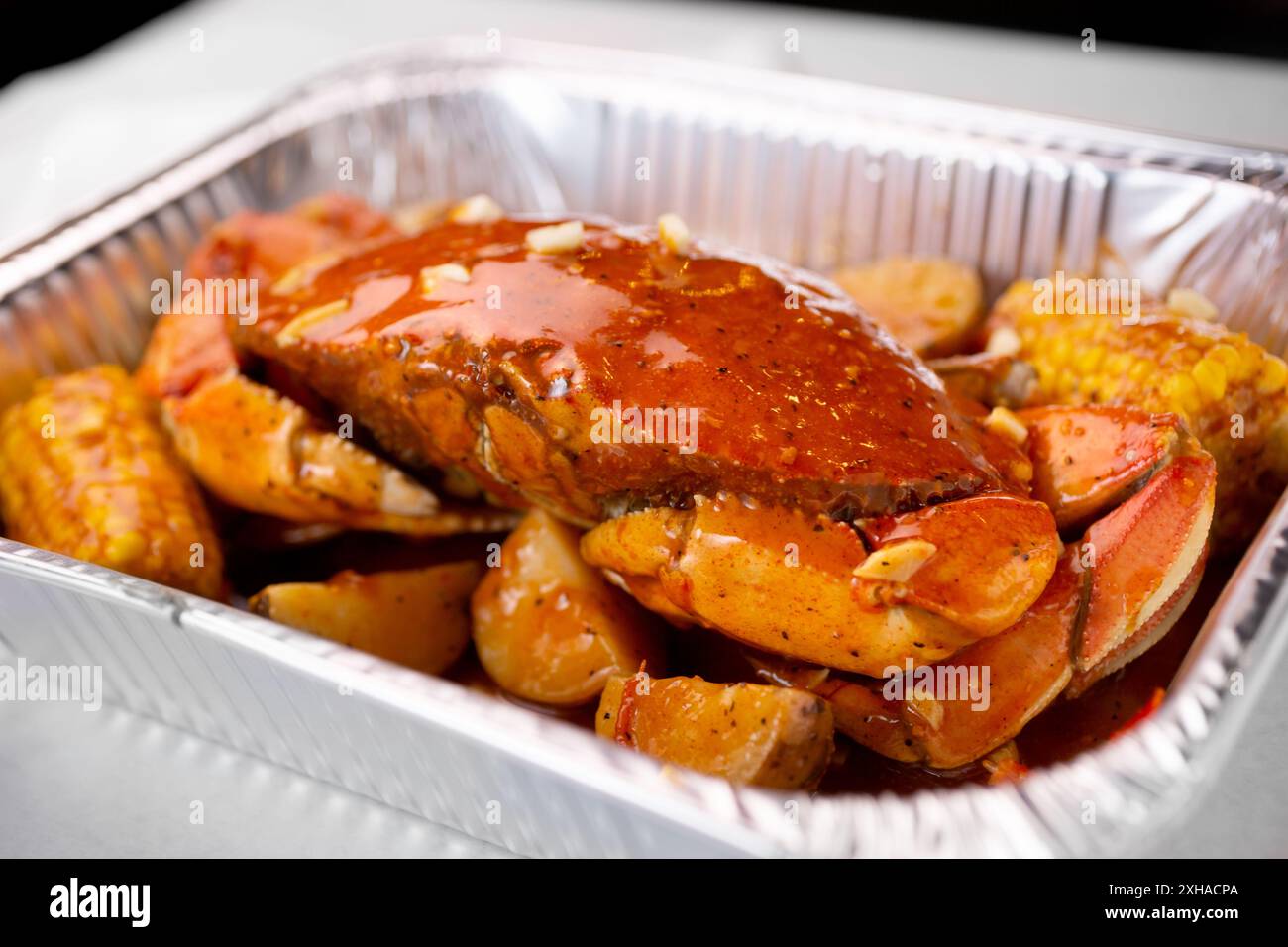 A view of a tin container of Dungeness crab boil Stock Photo - Alamy