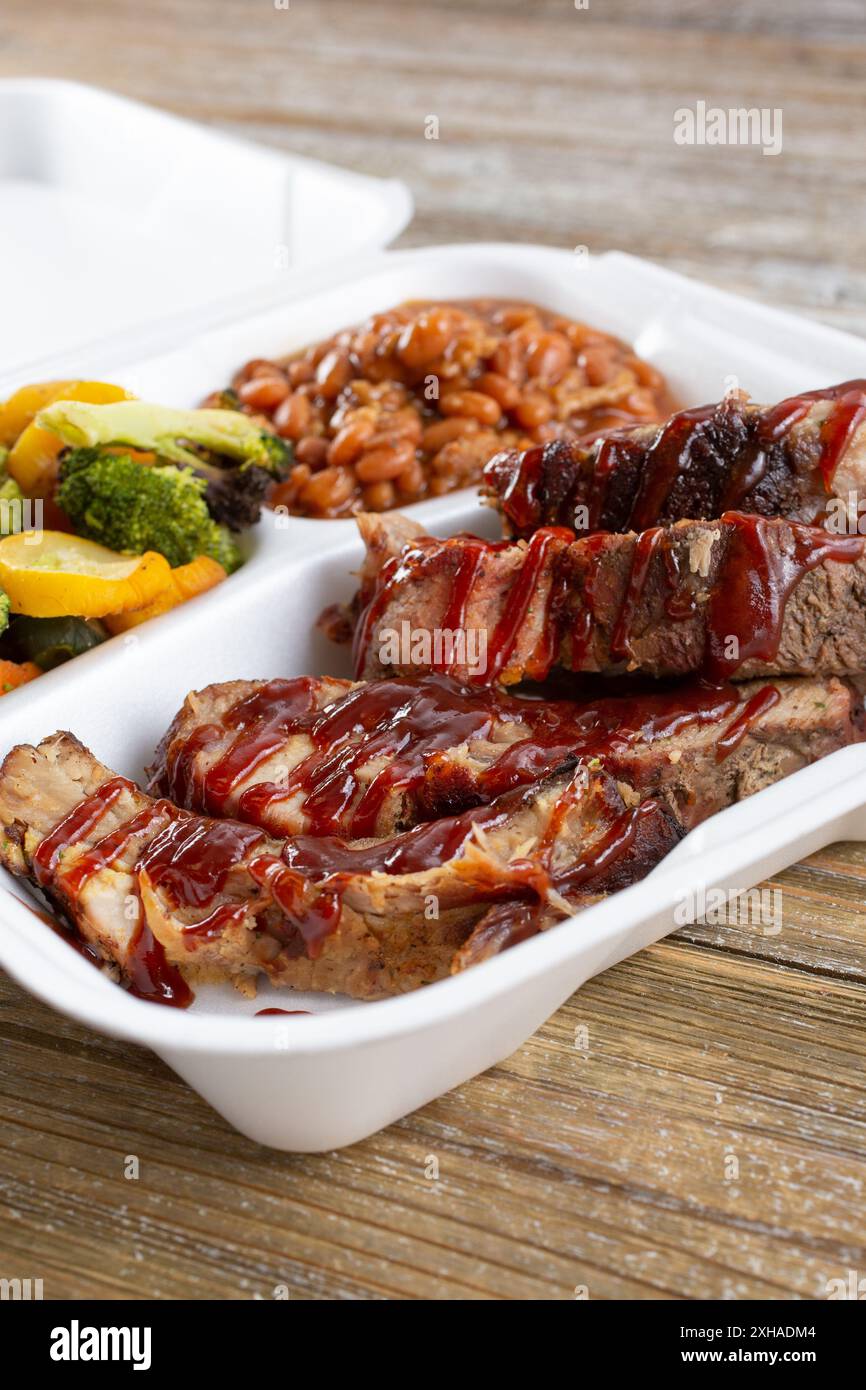 A view of a to-go container of BBQ pork ribs Stock Photo - Alamy
