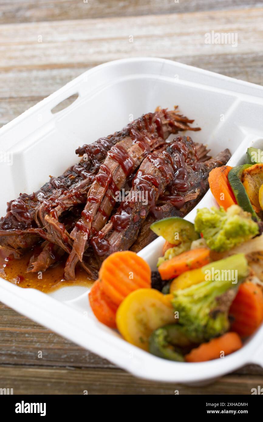 A view of a to-go container of BBQ brisket Stock Photo - Alamy