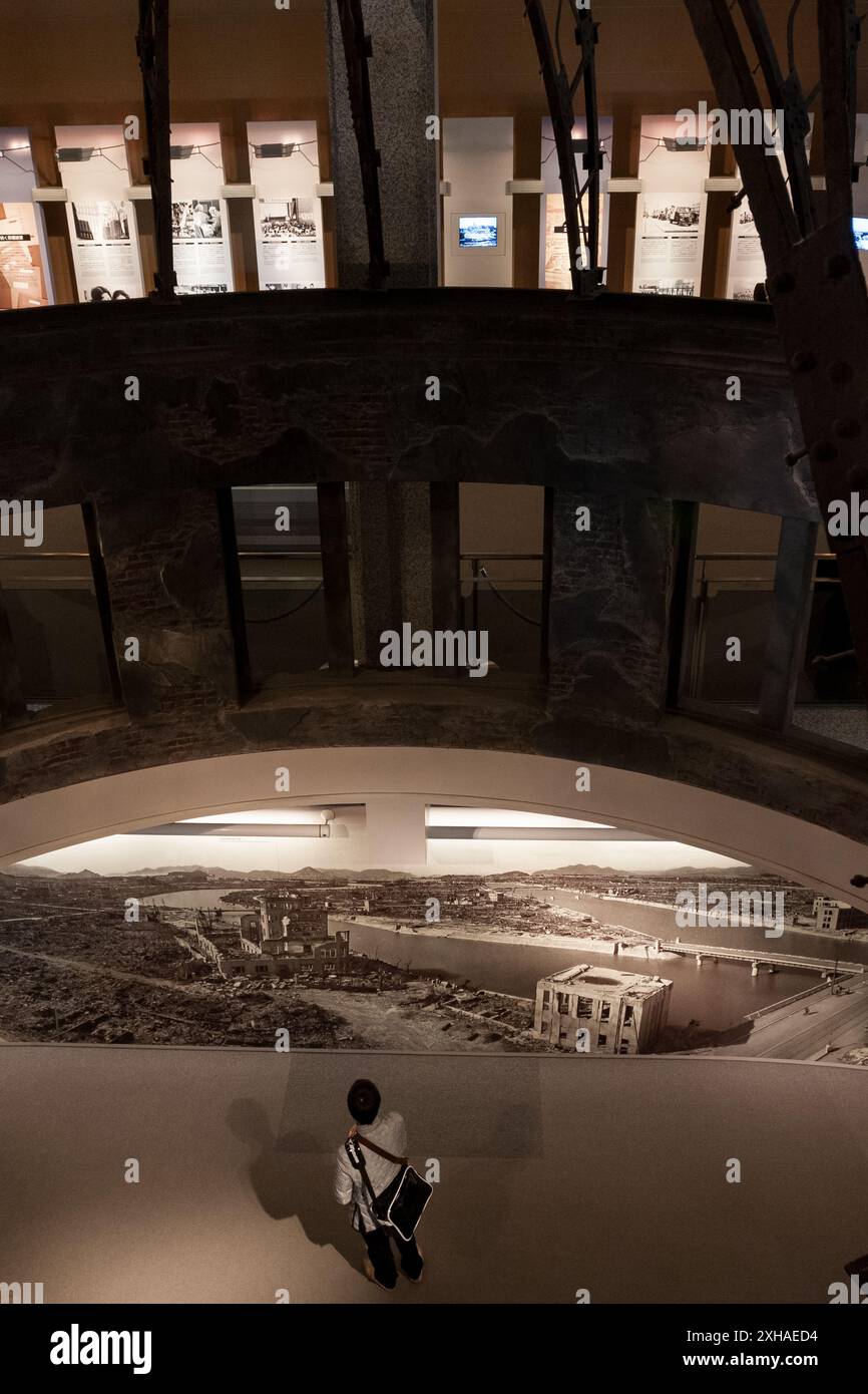 A tourist in the Atom bombing museum looks at images of the bombing ...
