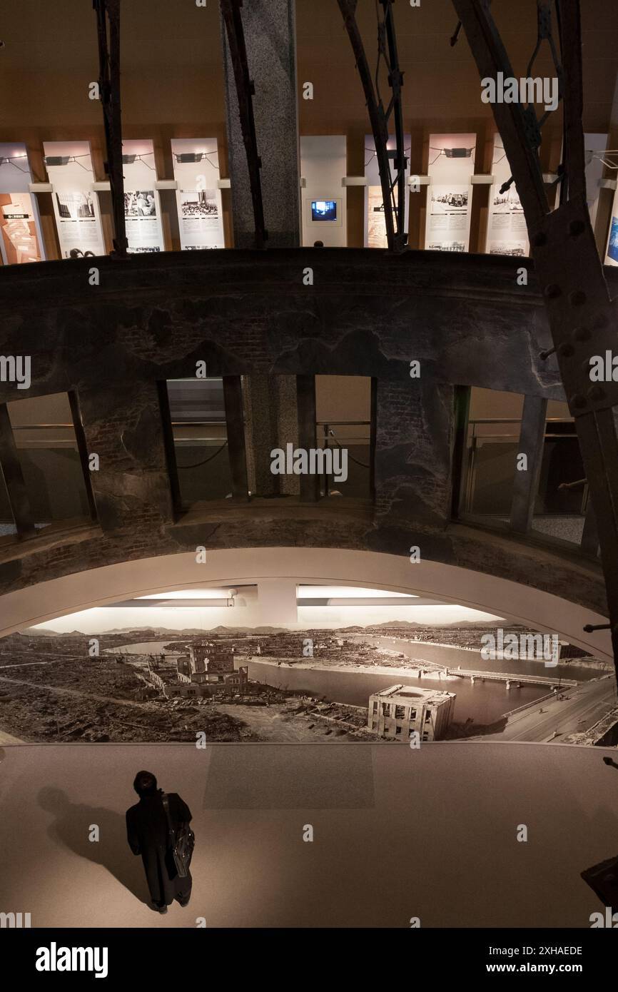 A tourist in the Atom bombing museum looks at images of the bombing ...