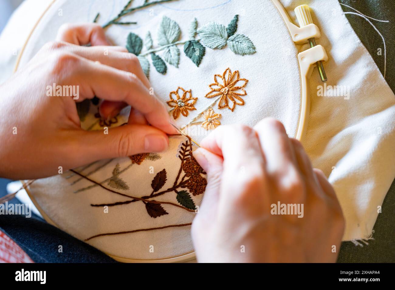Woman's hands working on embroidery with thread and needle Stock Photo ...