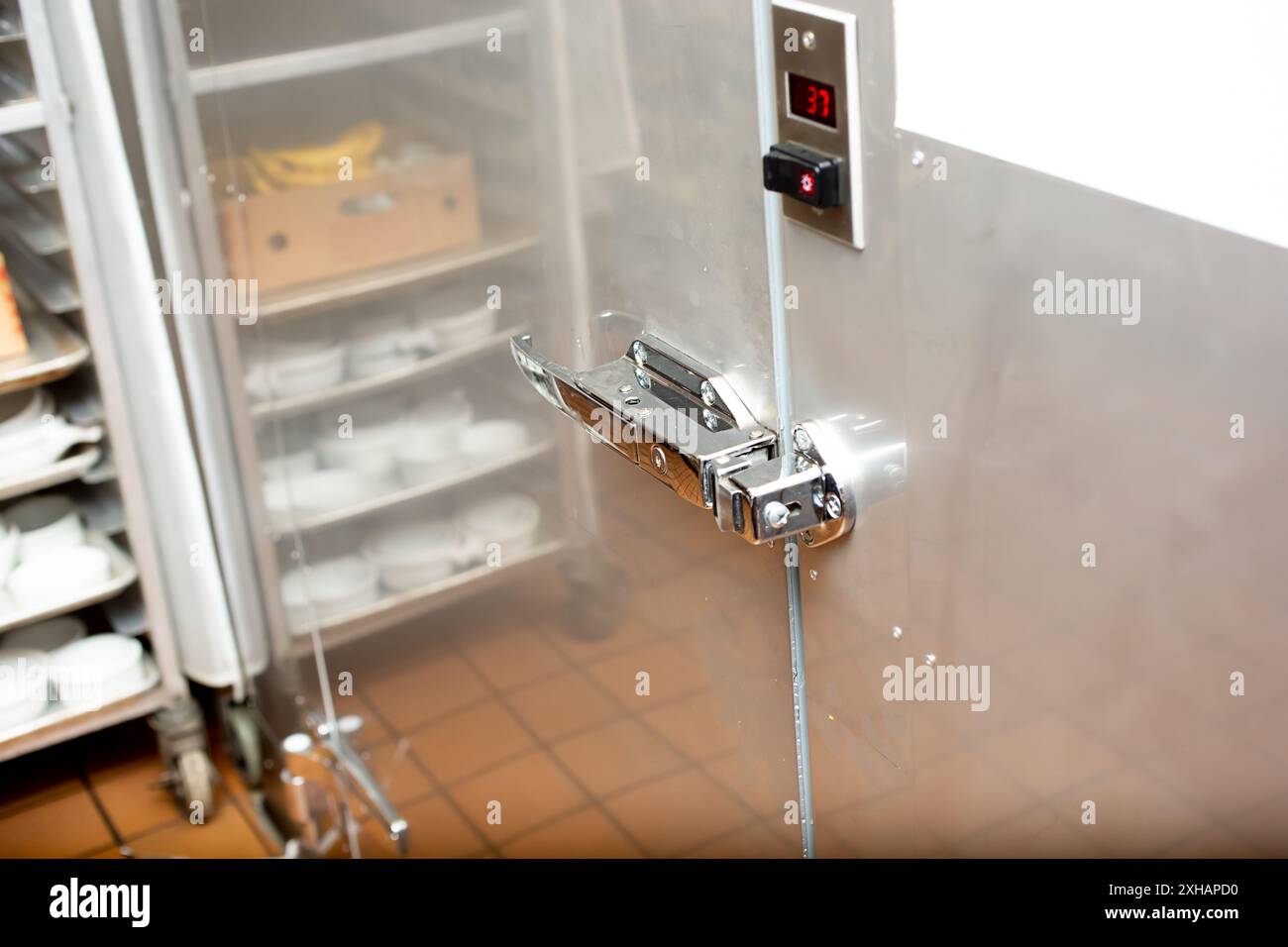A view of a door handle that leads to a walk-in fridge inside a ...