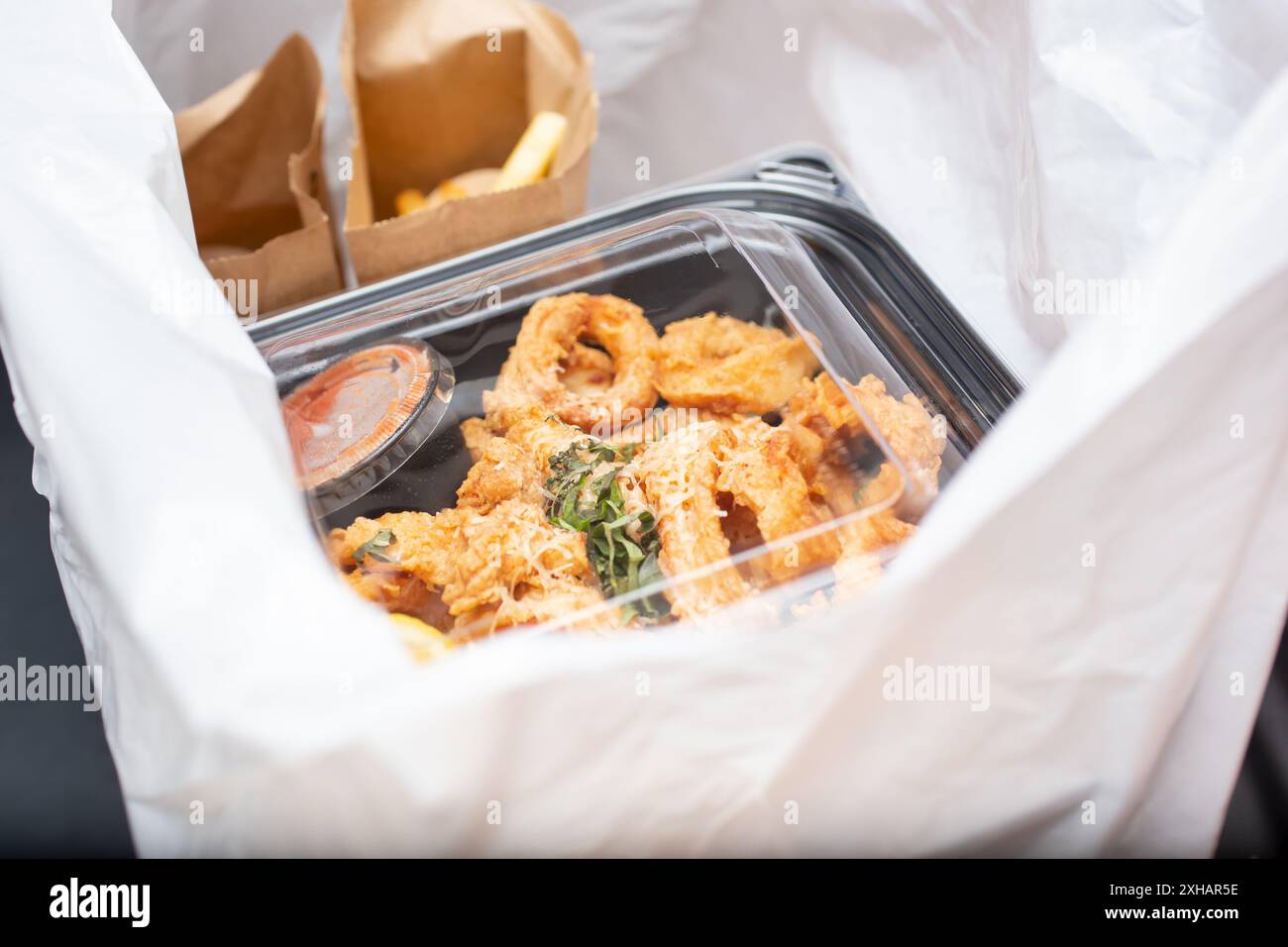 A view inside a plastic bag, featuring to-go containers of prepared ...