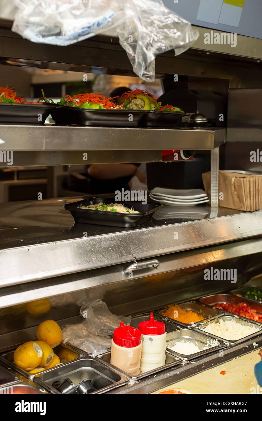 A view of a food prep station inside a restaurant kitchen, featuring a ...