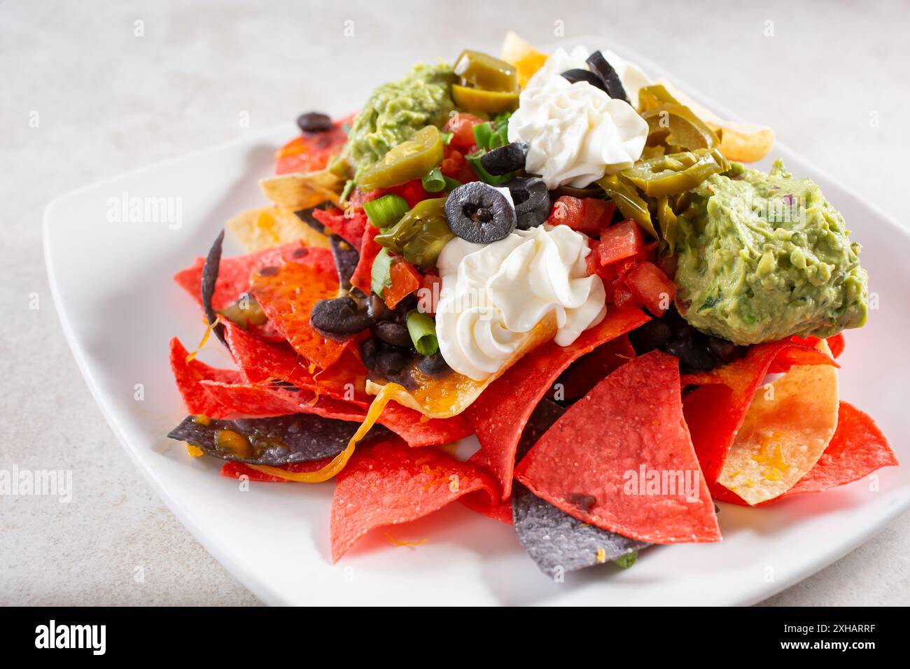 A view of a plate of colorful nachos Stock Photo - Alamy
