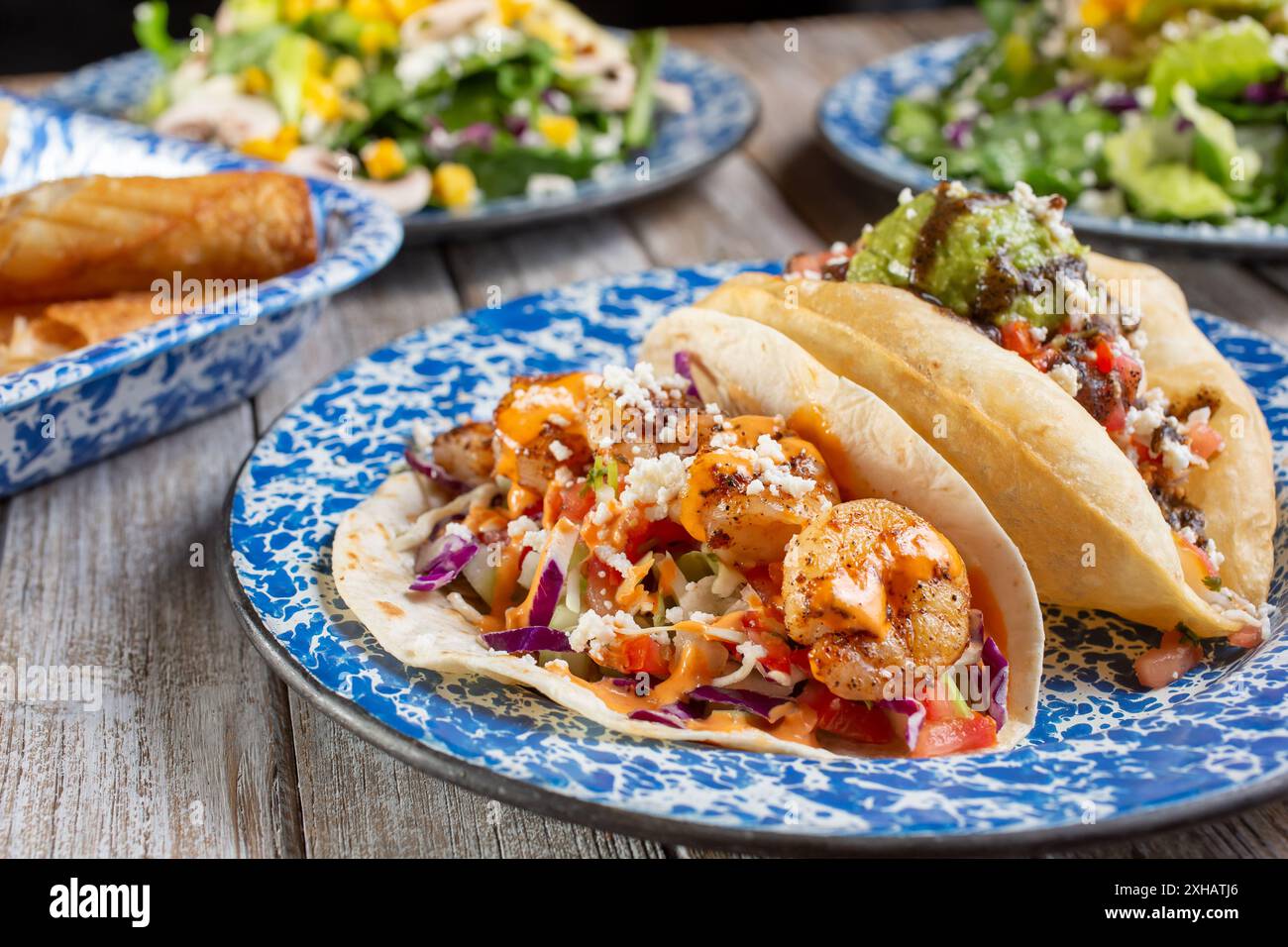 A view of a Tex Mex meal layout, featuring shrimp tacos Stock Photo - Alamy