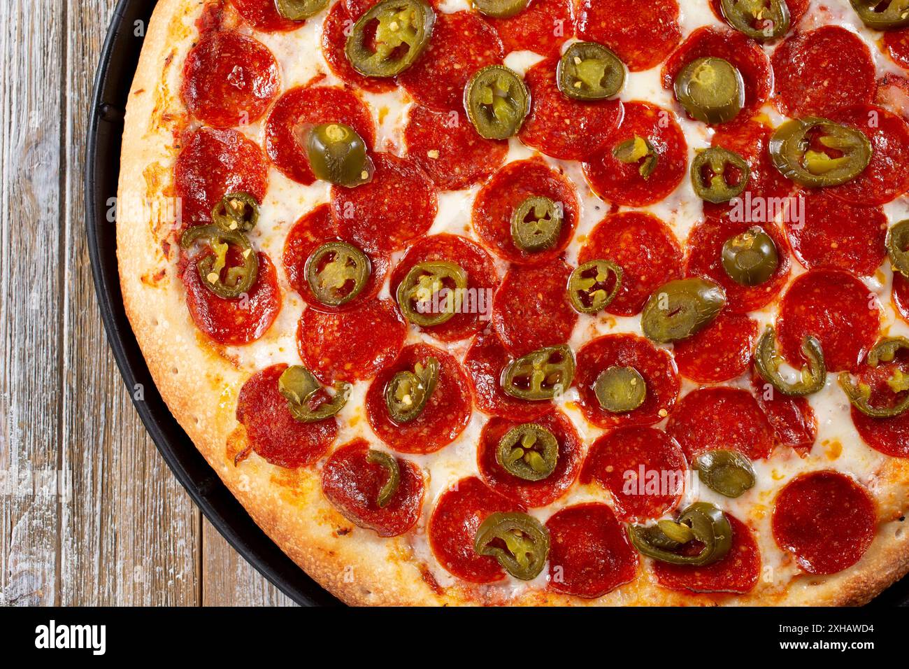 A top down view of a pizza pie featuring toppings as pepperoni and ...