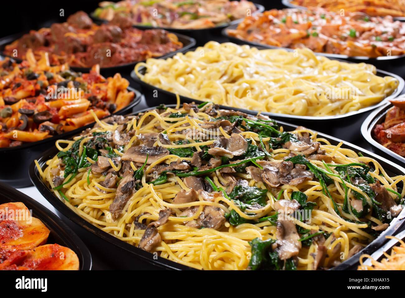 A view of several varieties of pasta trays, featuring a tray of ...