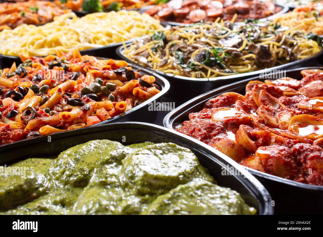 A view of several varieties of pasta trays, featuring arrabbiata ...