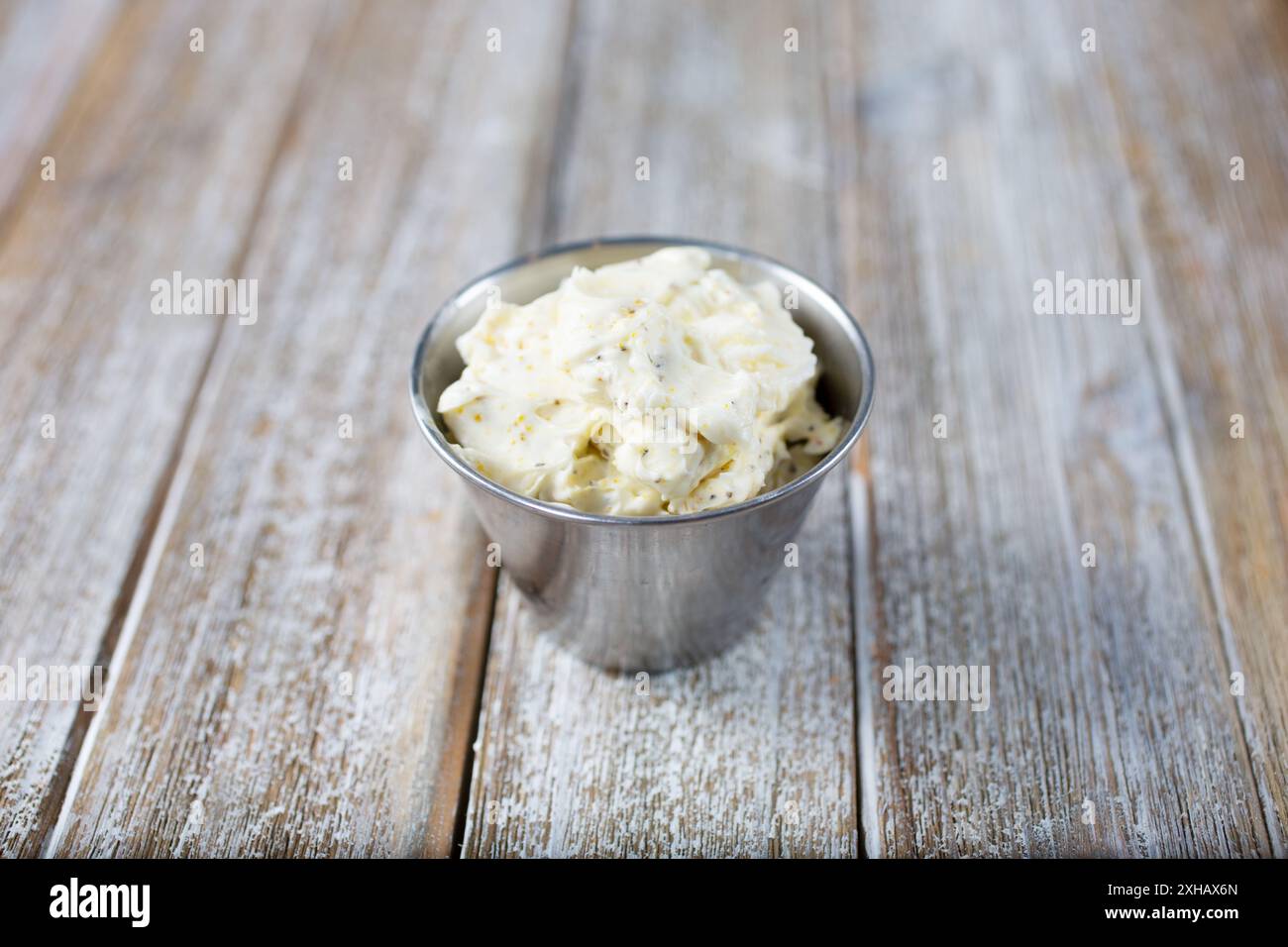 A view of a metal condiment cup of compound butter Stock Photo - Alamy