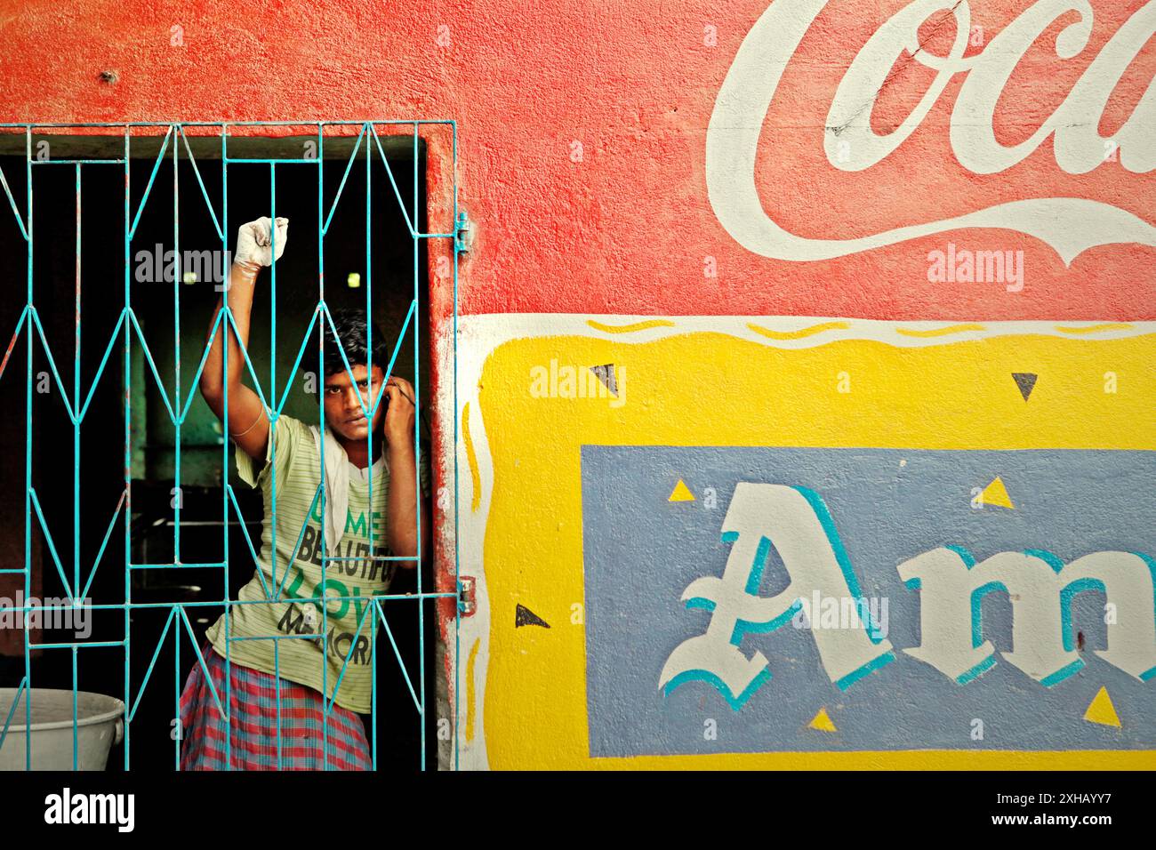 Portrait of a worker having phone conversation at the back door of a of ...