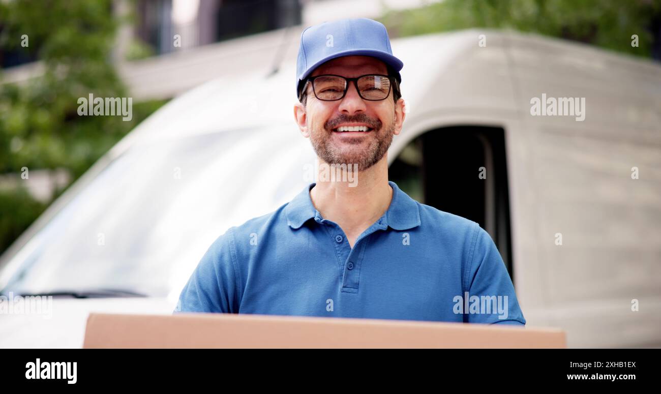 Cheerful Professional Delivery Man Transporting Cardboard Boxes ...
