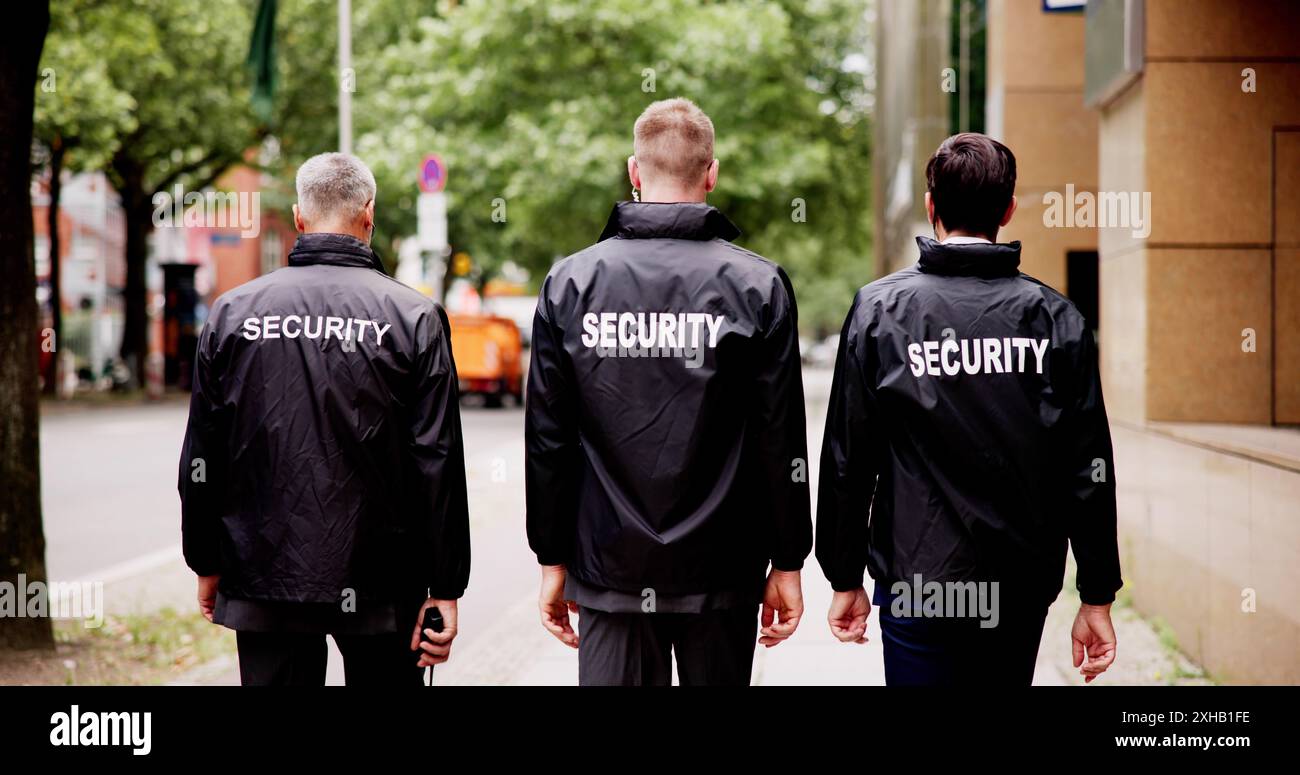 Caucasian Security Officer in Uniform Leading Group of Event Staff on ...