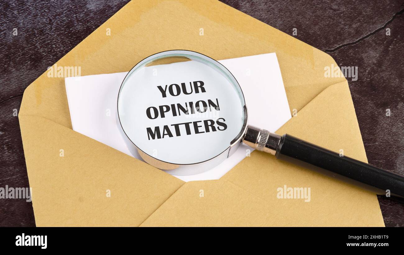 Business concept. Copy space. The text YOUR OPINION MATTERS through a ...