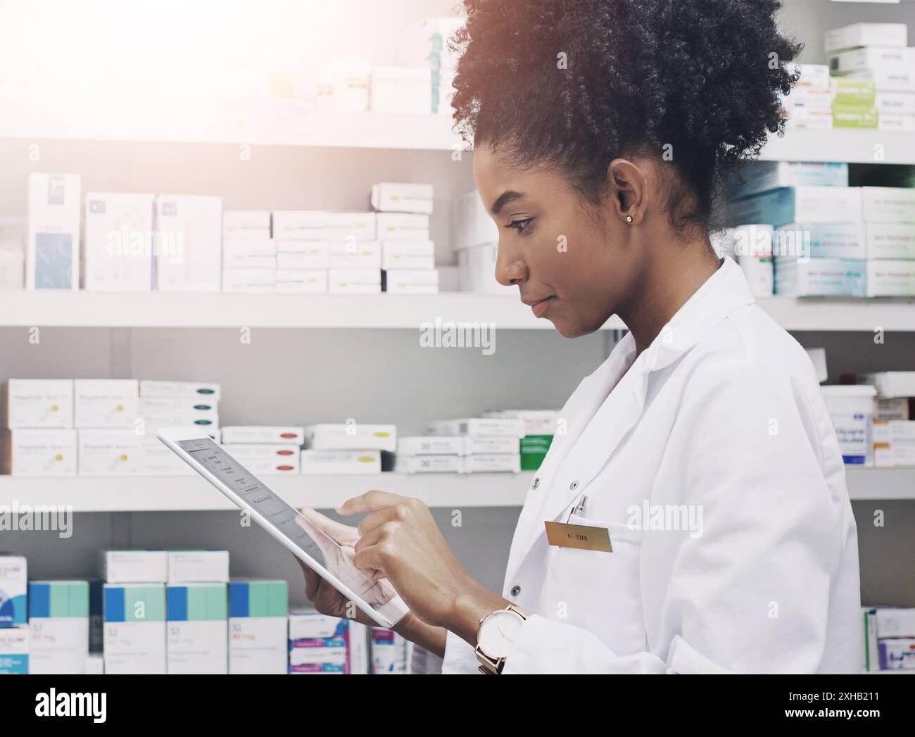 Pharmacy, woman and tablet with typing, medical and internet with ...