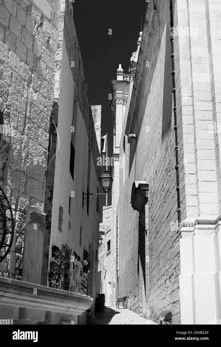 Black and white image of a narrow, historic alleyway showcasing rustic ...