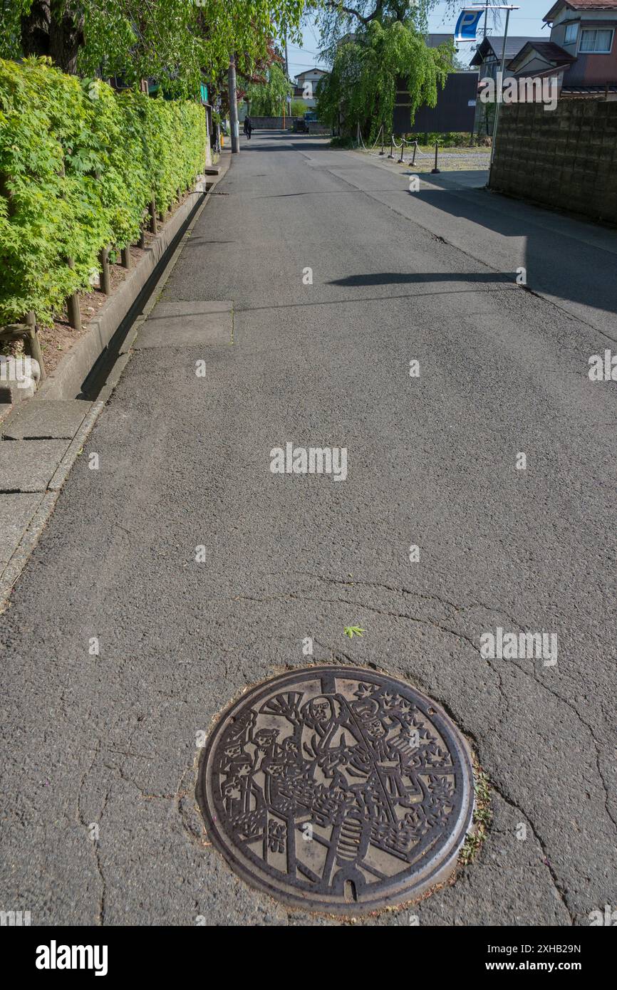 A samurai-themed man hole cover near Samurai Street, Kakunodate, Akikta ...