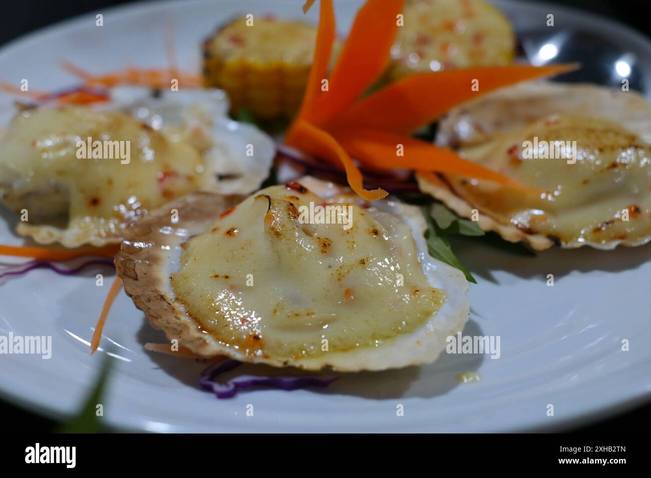 Grilled scallops on white plate in restaurant, close up Stock Photo - Alamy