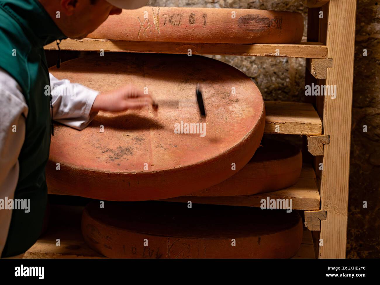 Cheese check in aging rooms with many shelves in caves, central ...