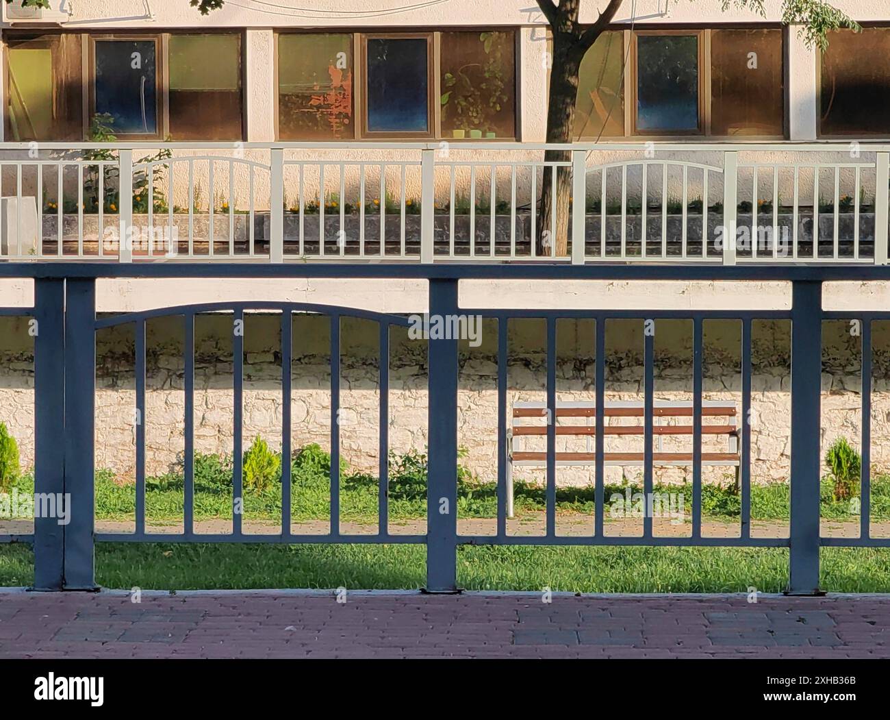 Urban Symmetry in the Cityscape: Metal Fence, Window Frames, and Street ...