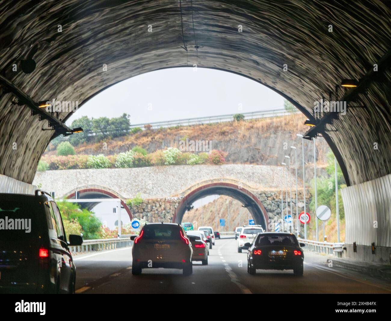 Cars drive through a tunnel on leaving on holiday Stock Photo - Alamy