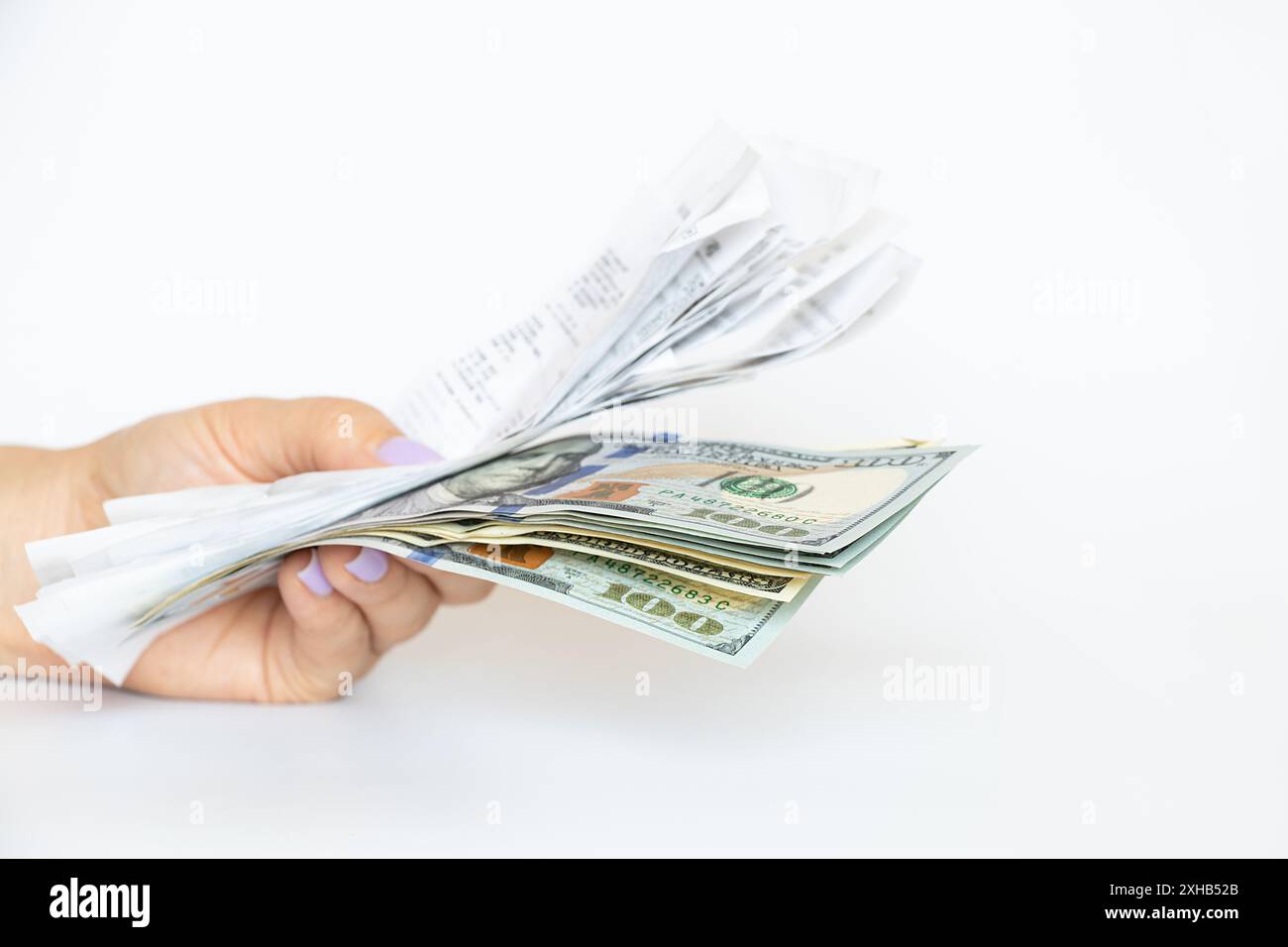 In the hands of a girl are receipts from a grocery store and dollars on ...