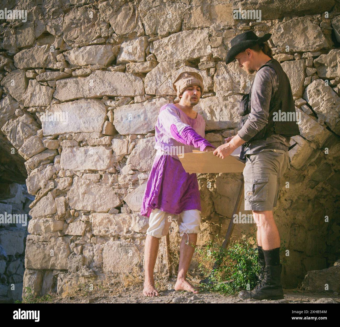 The archaeologist shows a map to a local mercenary of Arab appearance ...