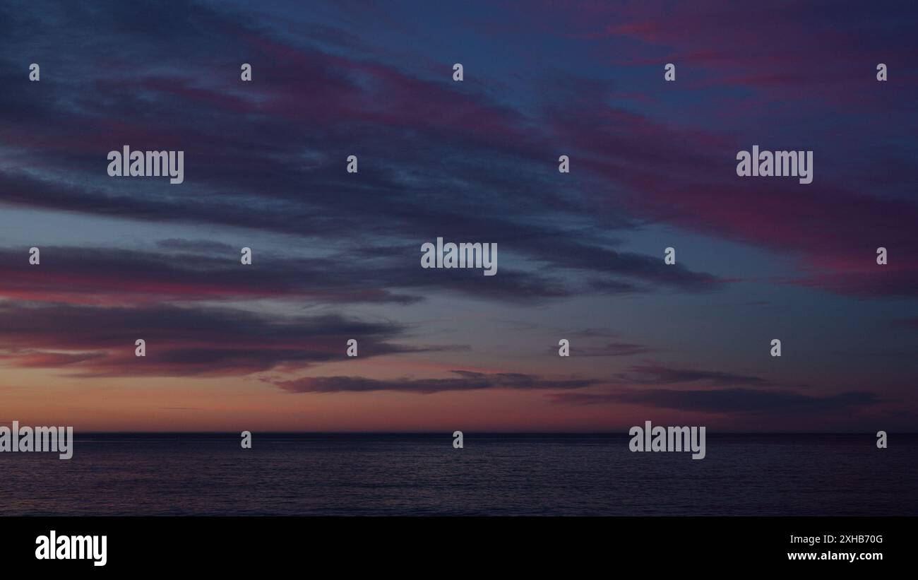 Beautiful purple sunset over waves hi-res stock photography and images ...