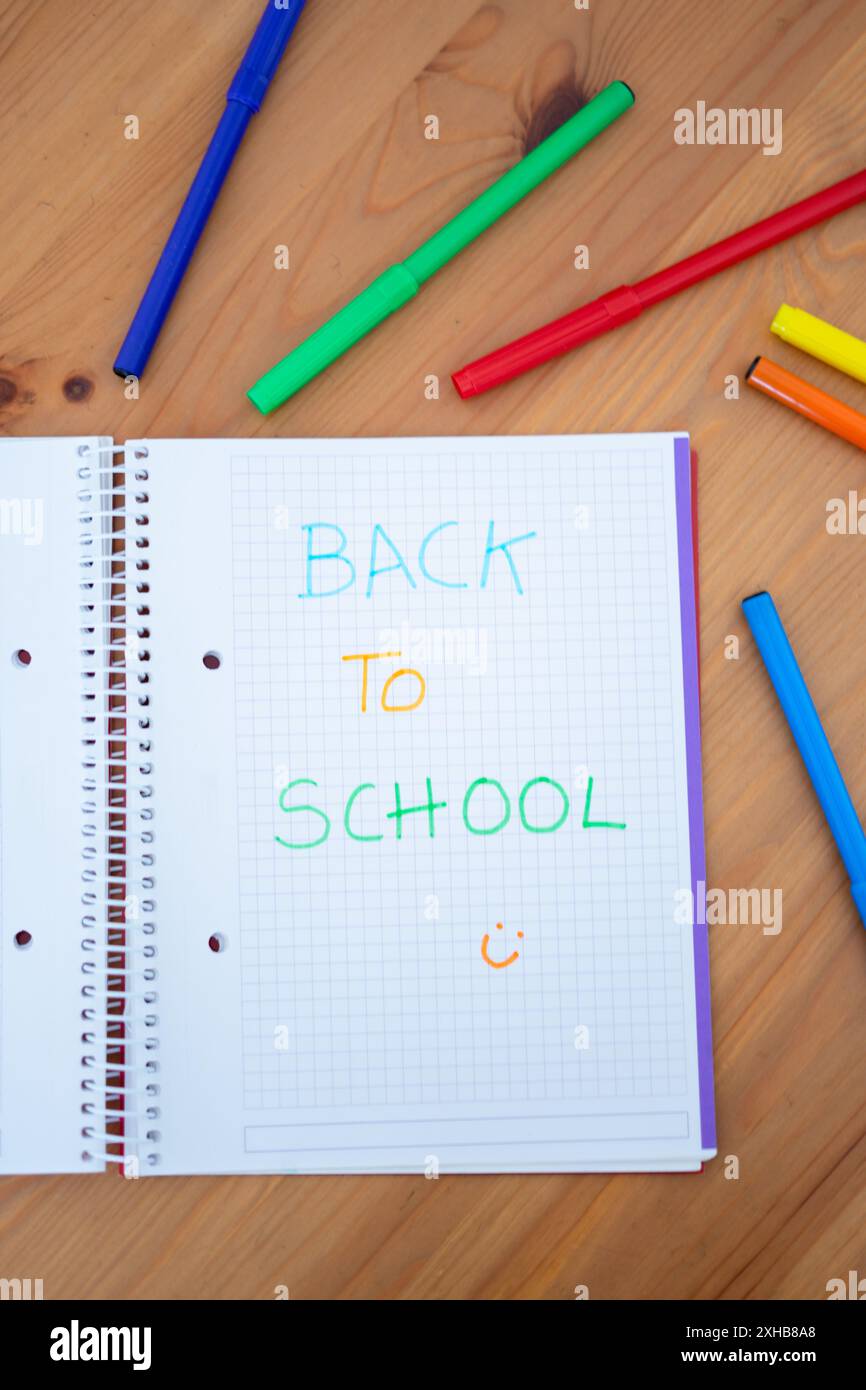 Notebook with the words "Back to school" written with colored markers ...