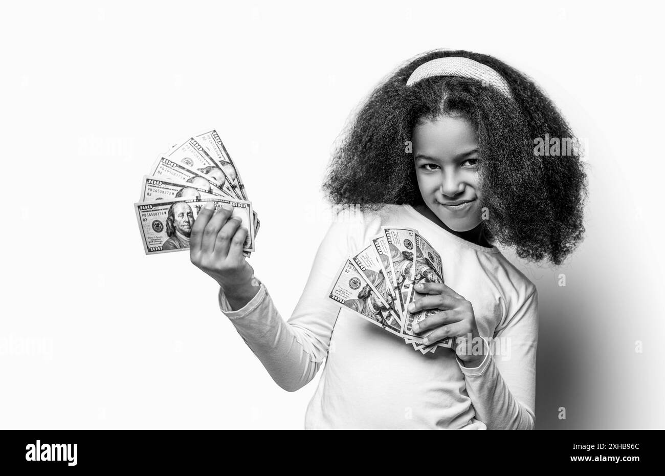 Child girl holding money, smiling holding dollars 100. Portrait of ...