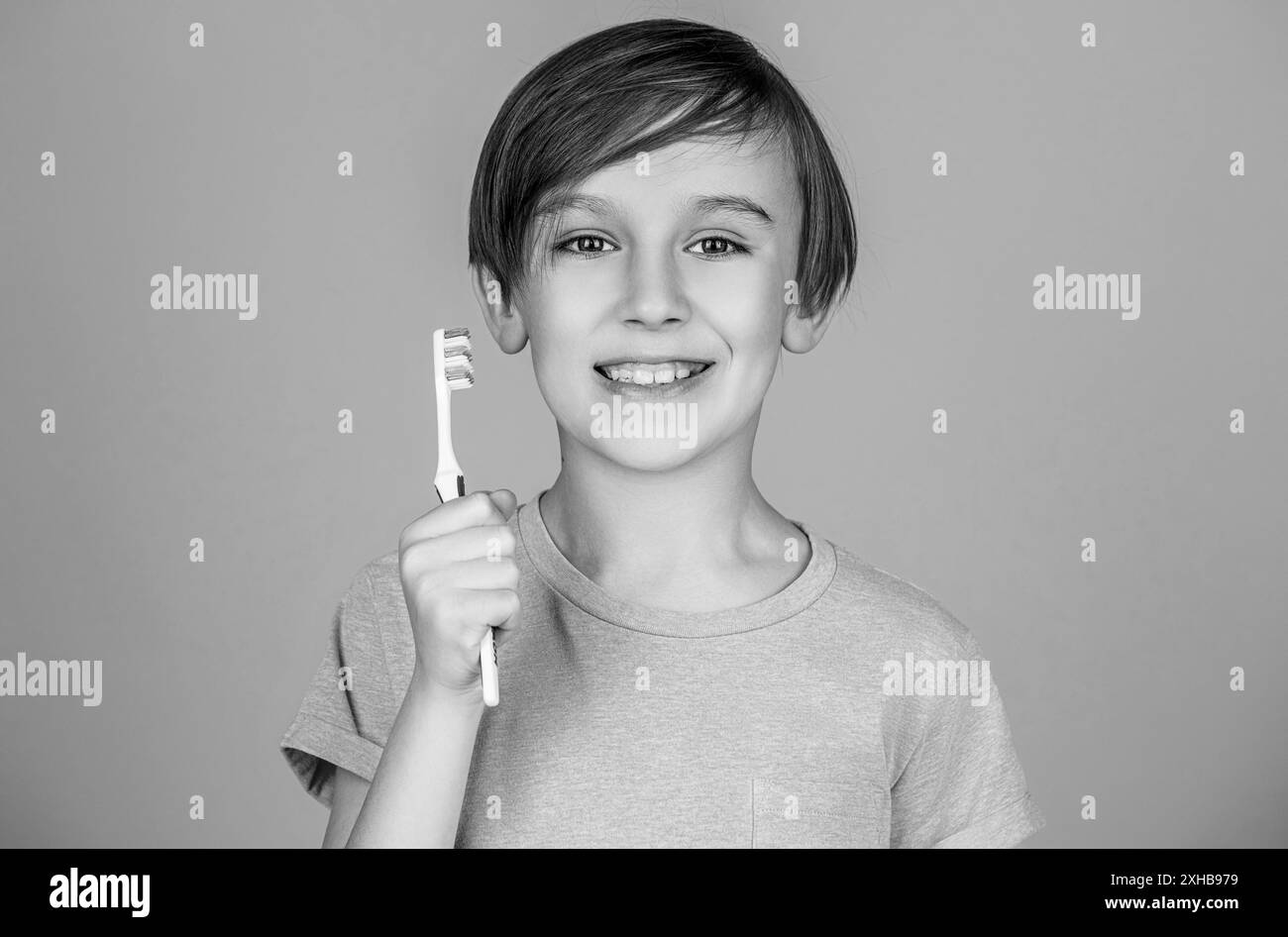 Kid brushing teeth with white toothbrush. Beautiful boy brushing teeth ...