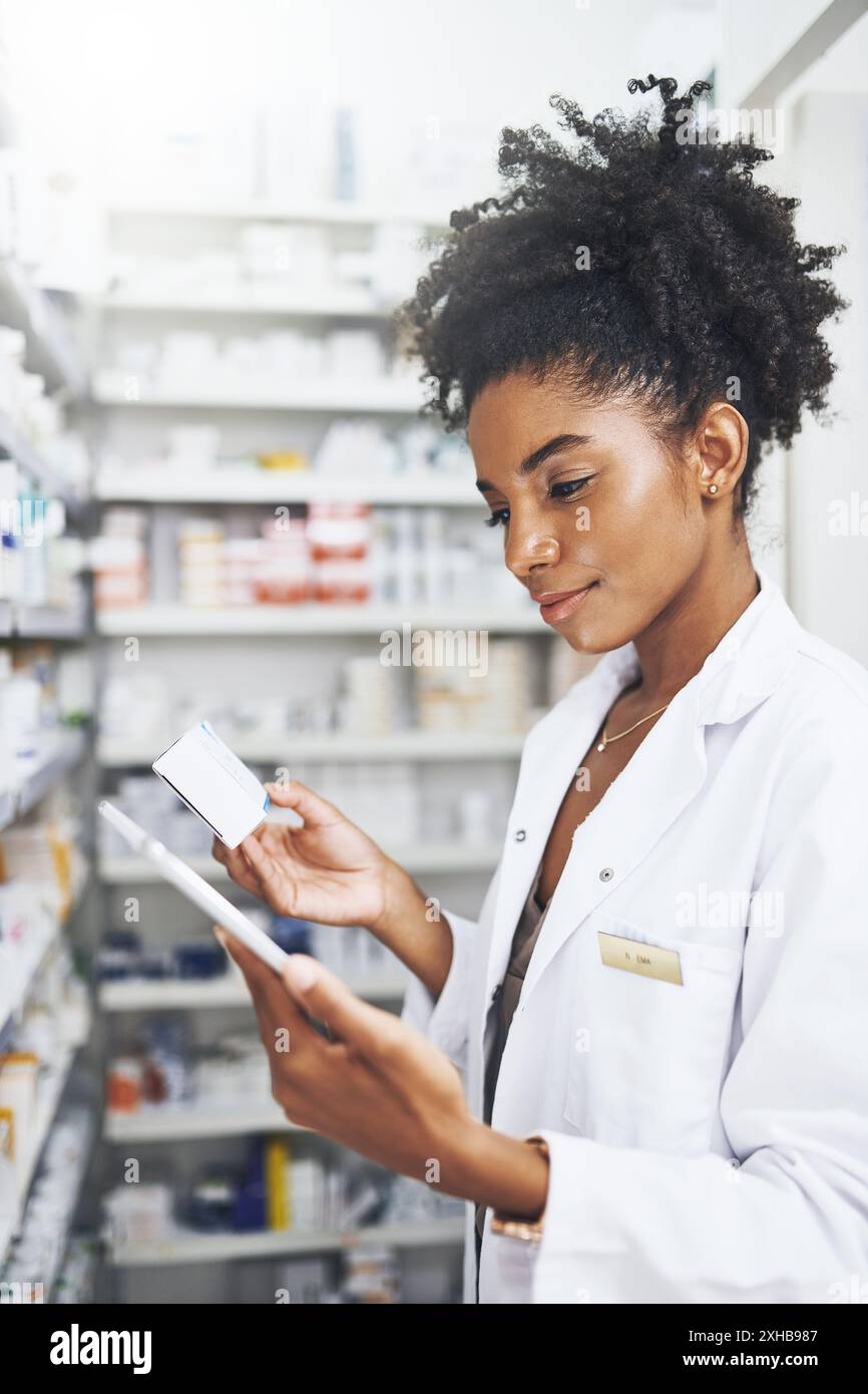 Black woman, tablet and pharmacist reading medicine label for stock ...