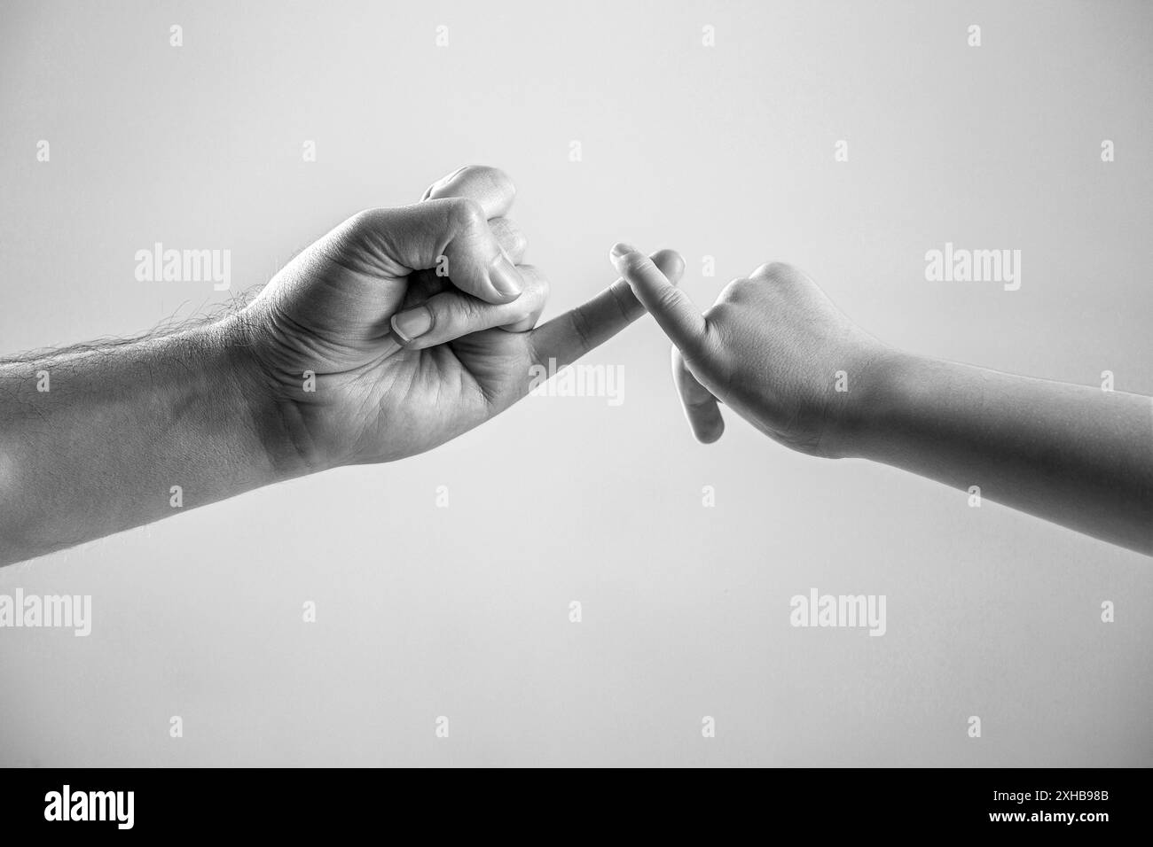 Two hands hook pinky fingers together to promise, swear or asking for ...