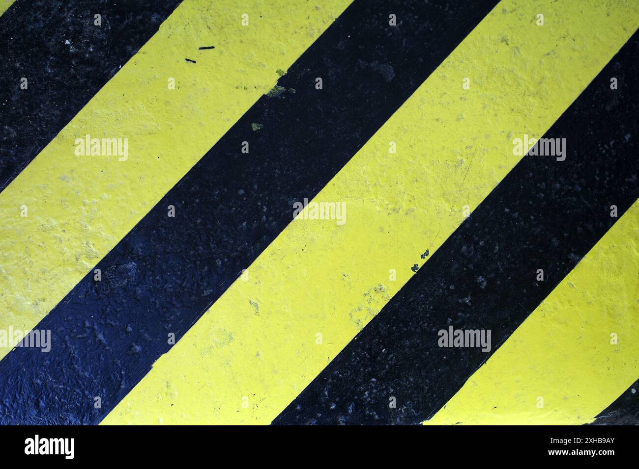 Detail of a yellow, black painted threshold with diagonal lines ...