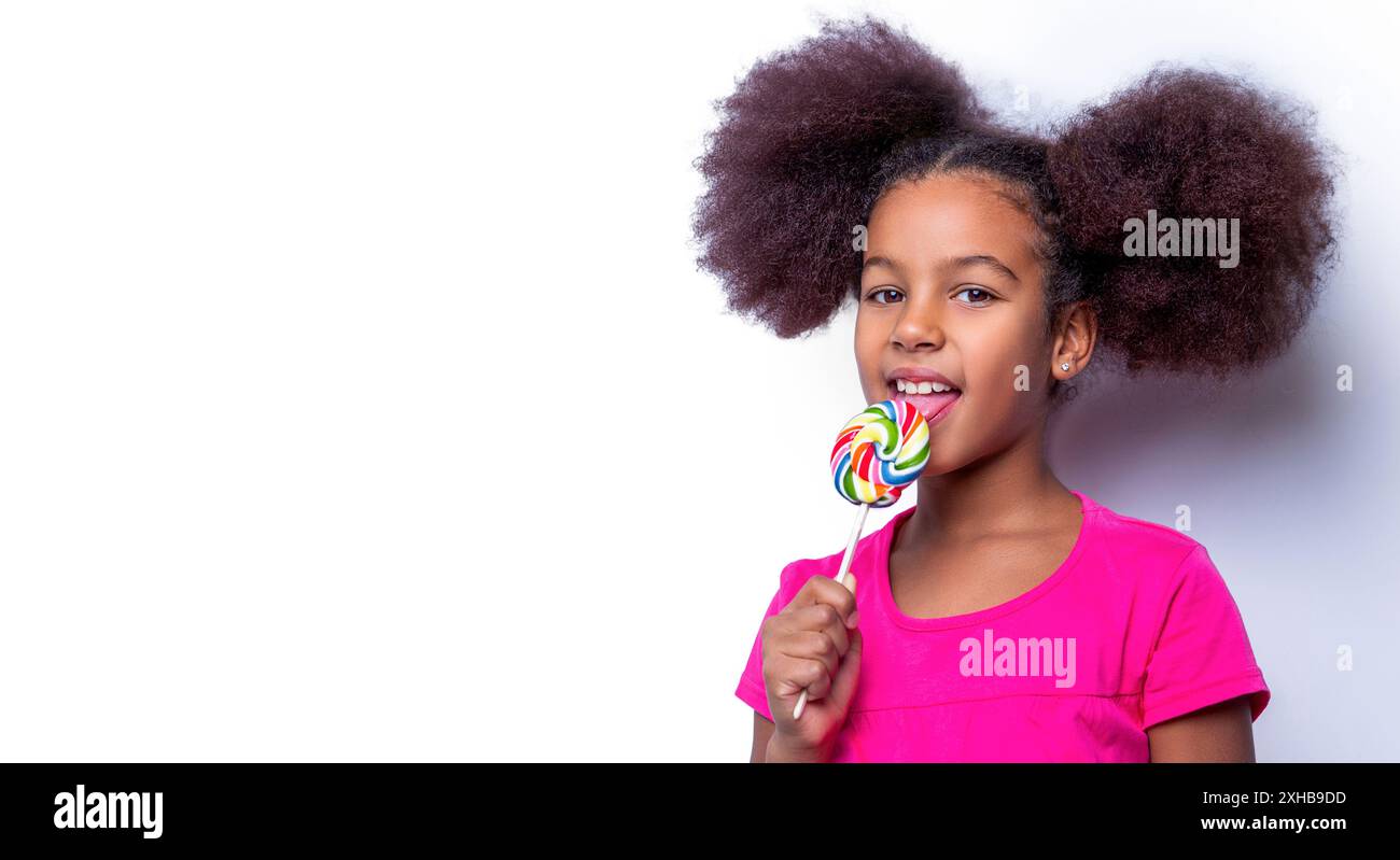 Adorable little african american girl holding lollipop candy in hands ...