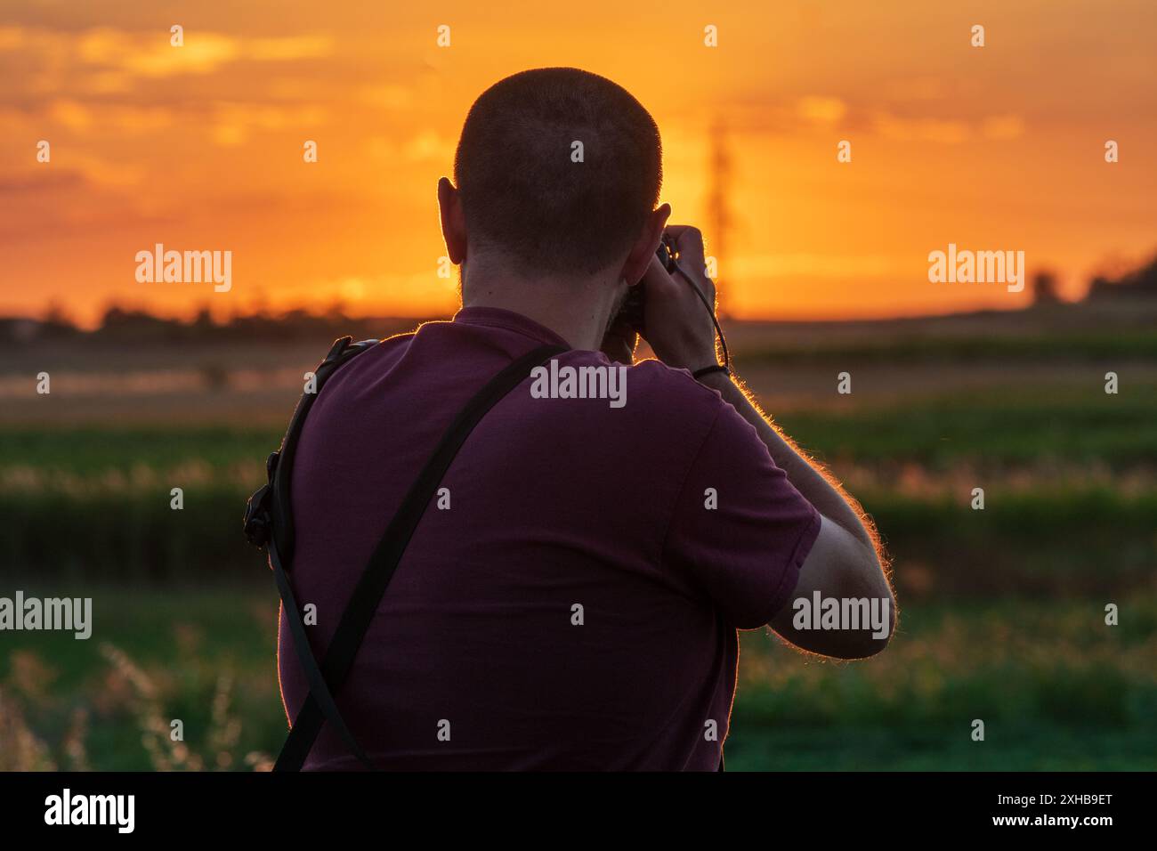 Catcher of the Sun. Photographer Capturing Sunset, Shot from Behind ...