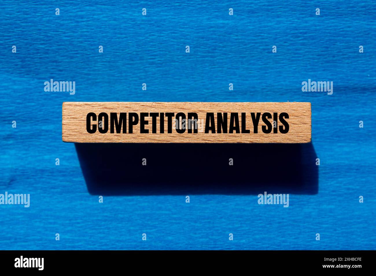 Competitor analysis message written on wooden block with blue ...