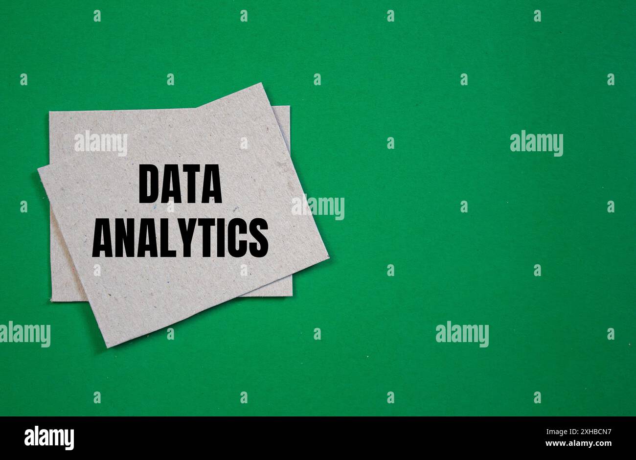 Data analytics message written on paper piece with green background ...