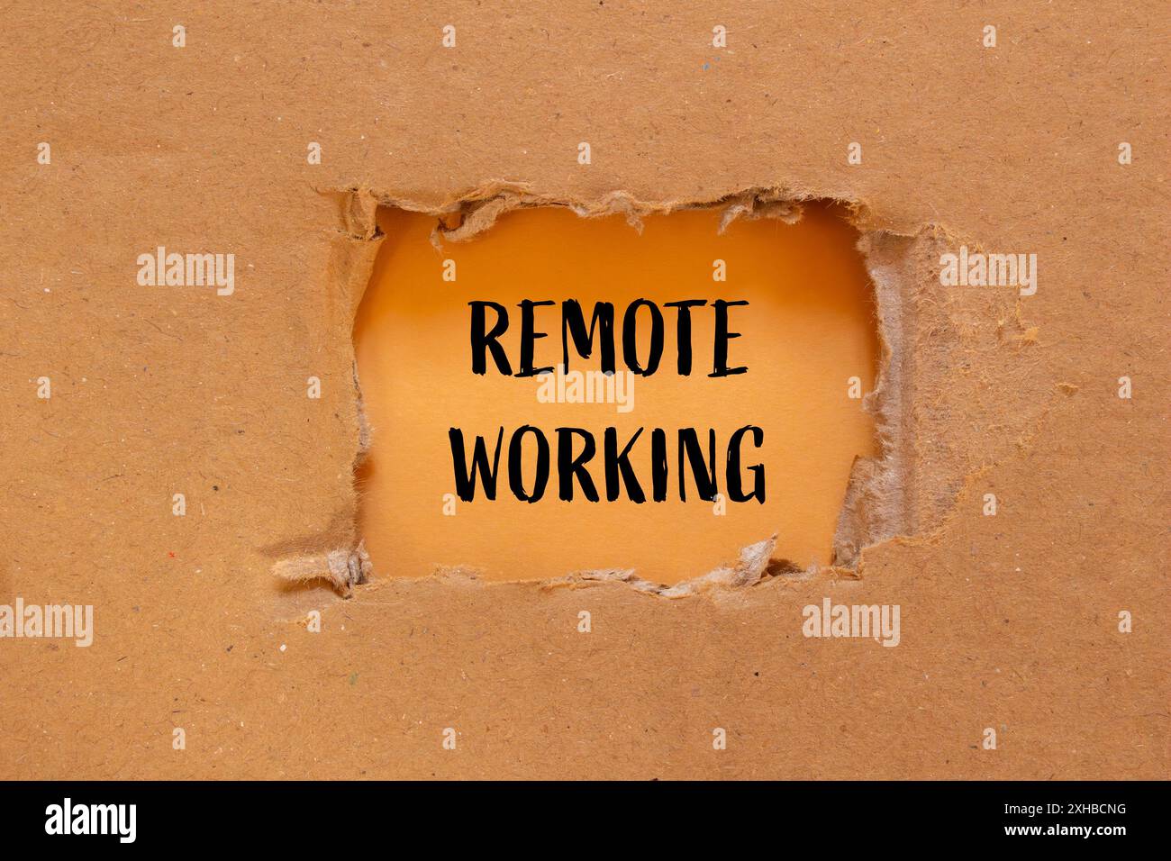 Remote working message written on ripped cardboard paper with orange ...