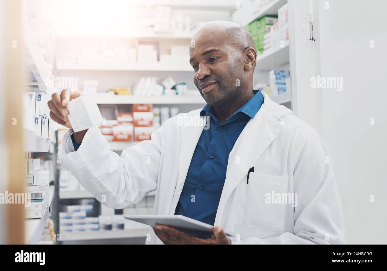 Black man, tablet and pharmacist check medicine for stock, inventory or ...