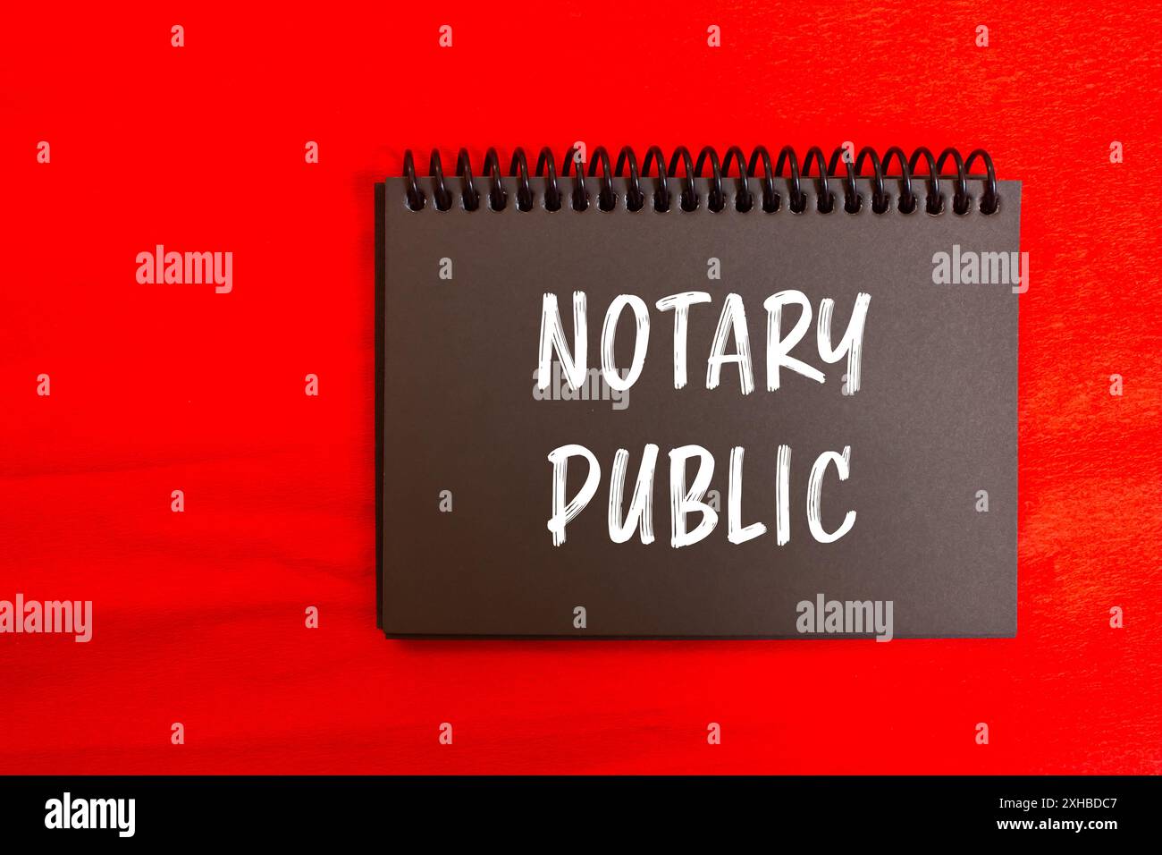 Notary public message written on black notebook page with red ...