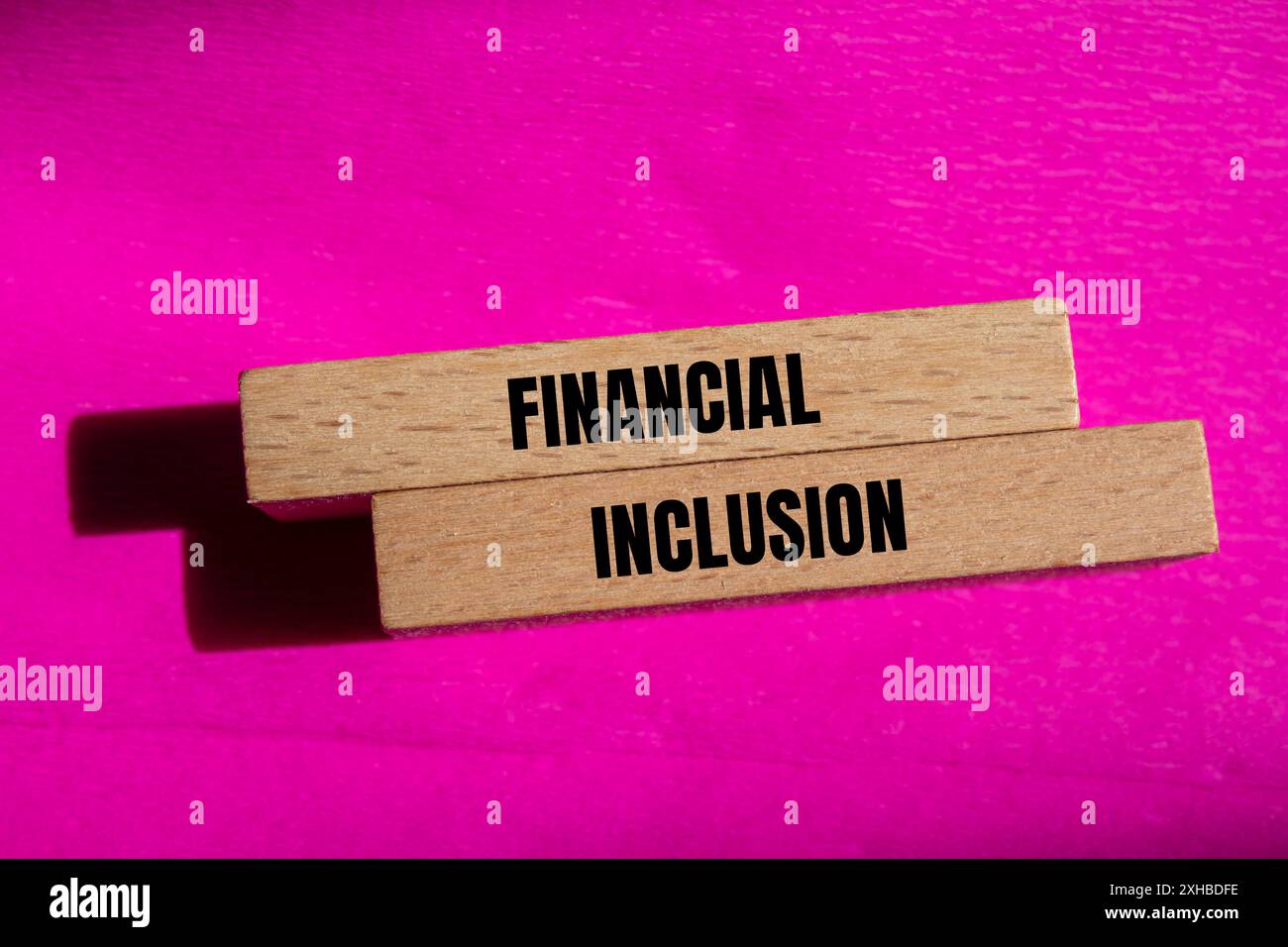 Financial inclusion message written on wooden blocks with pink ...
