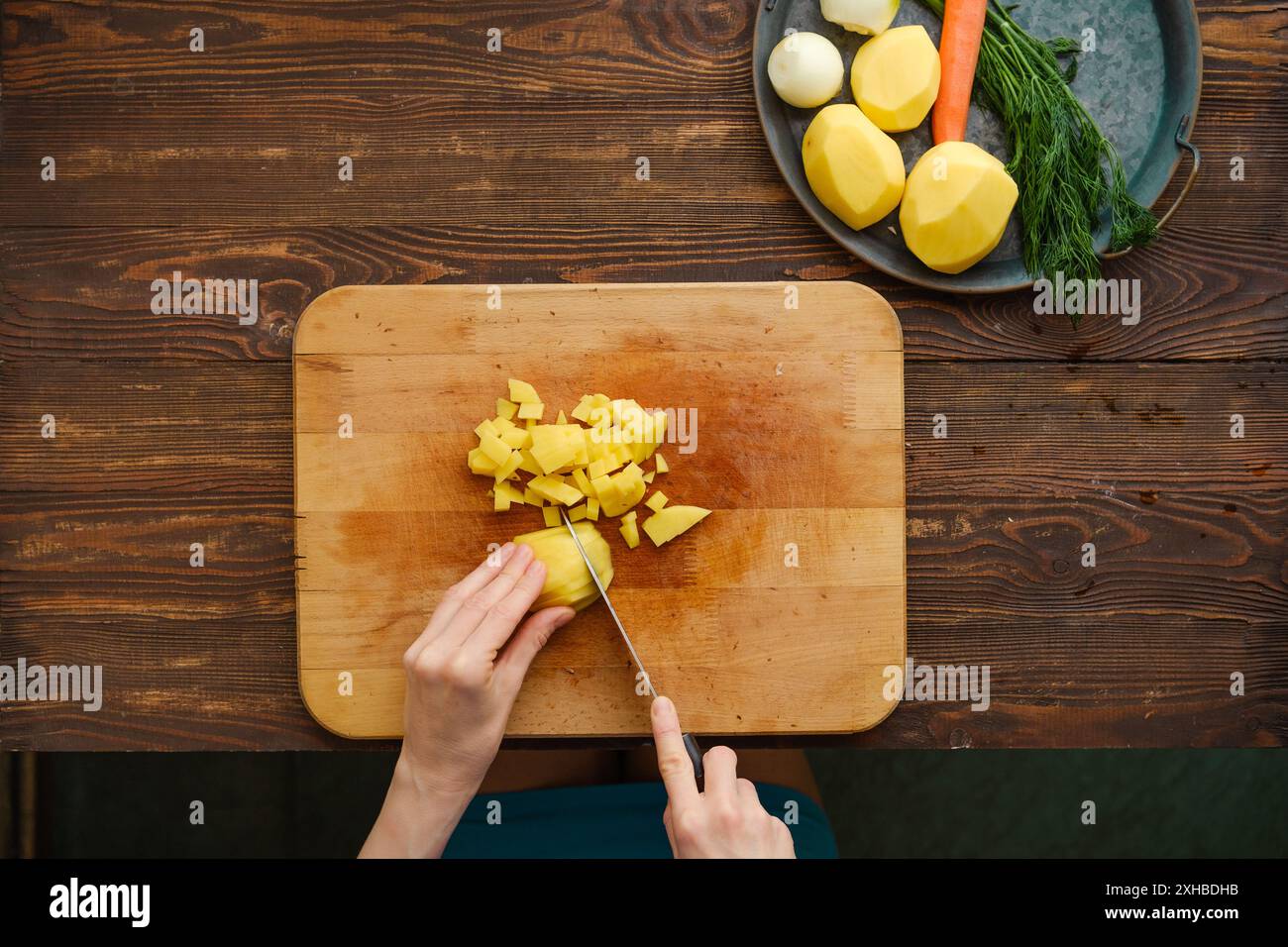 Unrecognizable woman chopping peeled potato, top view Stock Photo - Alamy